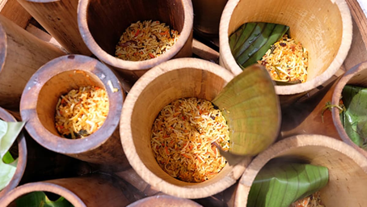 Serving up bamboo biryani... under a tree - TODAY