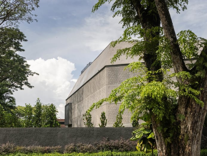 This fortress-like concrete house in Singapore hides a surprise within