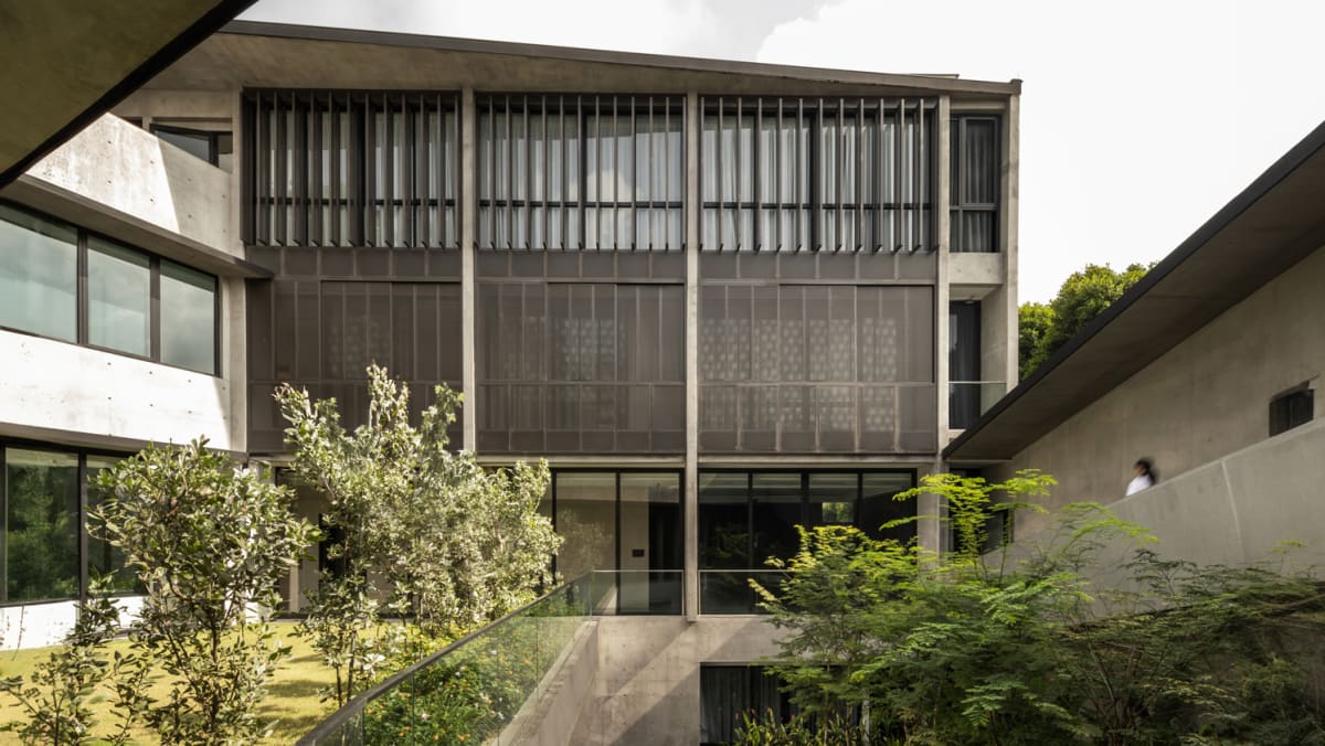 This fortress-like concrete house in Singapore hides a surprise within