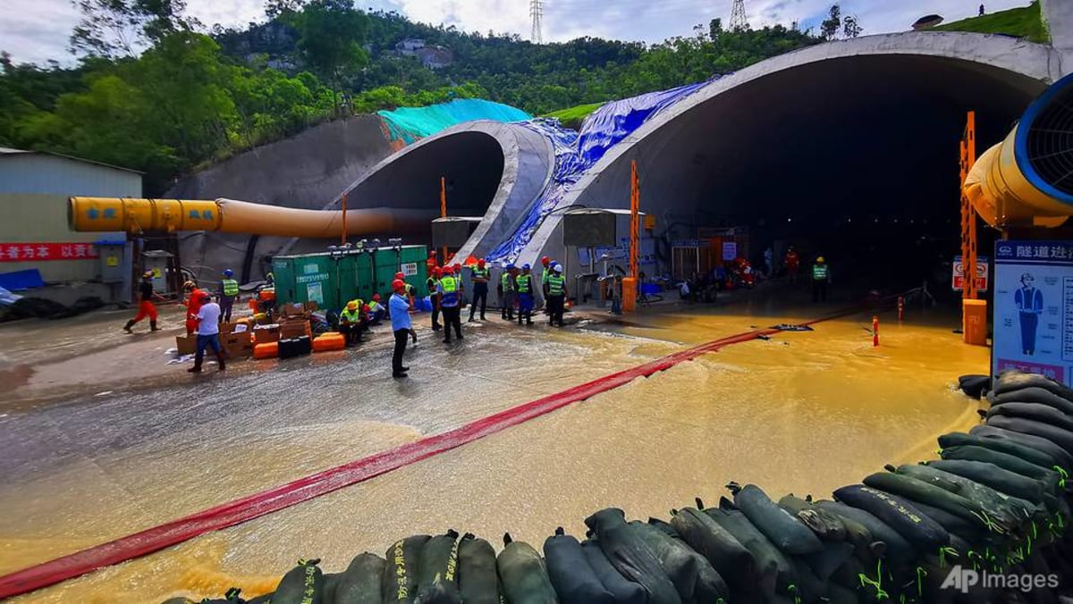 Divers join search for 14 people in flooded tunnel in China - CNA
