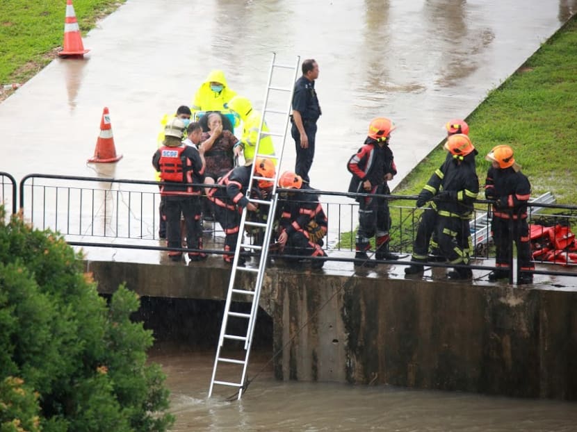 Dramatic rescue after duo fall into Macpherson canal amid heavy rain ...