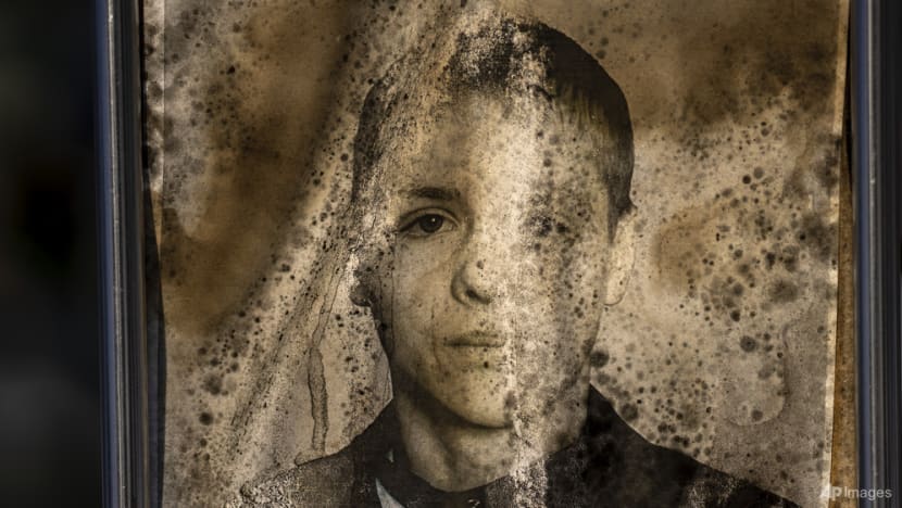 In pictures: The fading graveside portraits of Ukraine's war dead - CNA