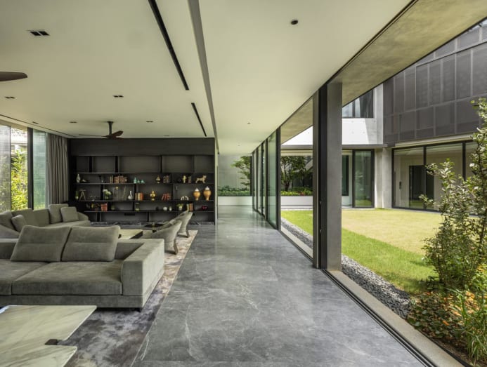 This fortress-like concrete house in Singapore hides a surprise within