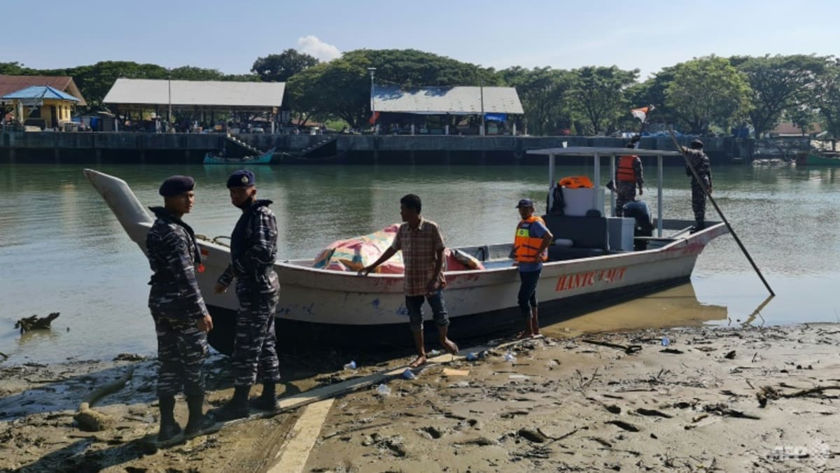 Indonesia navy ship tows boat with Rohingya refugees to port - CNA